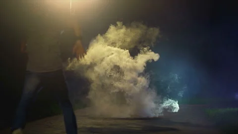 The man running in the cloud of smoke on... | Stock Video | Pond5