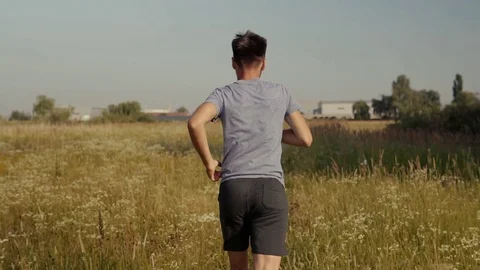 Man Running On Green Grass Field.Slow Mo... | Stock Video | Pond5