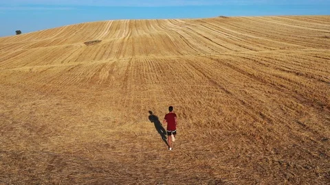 Man Running In Field Stock Footage ~ Royalty Free Stock Videos | Pond5