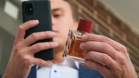 A man scans a qr code on a perfume bottl... | Stock Video | Pond5