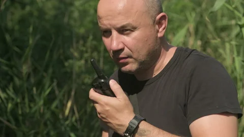 Man security guard talking on handheld w... | Stock Video | Pond5