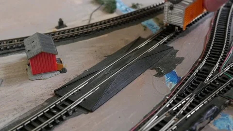 A man sets a replica model train onto th... | Stock Video | Pond5