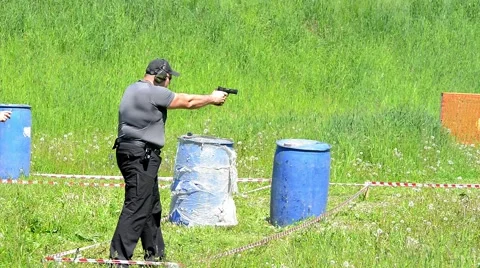 Man shoot with a gun in targets on shoot... | Stock Video | Pond5