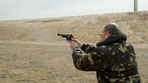 A man shooting a .357 magnum revolver ou... | Stock Video | Pond5