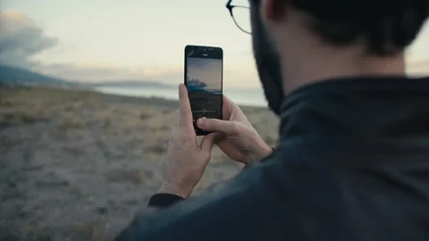 Man shooting video with his smart phone ... | Stock Video | Pond5