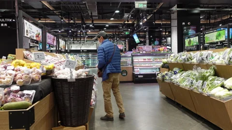 man shopping vegetables in a supermarket | Stock Video | Pond5