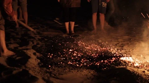 A man with a shovel shifts hot coals fro... | Stock Video | Pond5