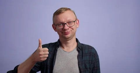 Man showing thumb up sign on blue backgr... | Stock Video | Pond5
