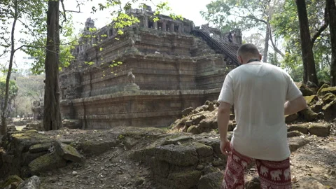 Man sightseeing ancient Angkor Wat templ... | Stock Video | Pond5