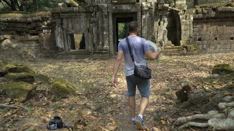 Man sightseeing ancient Angkor Wat templ... | Stock Video | Pond5