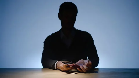 Man silhouette scrutinizing identity doc... | Stock Video | Pond5