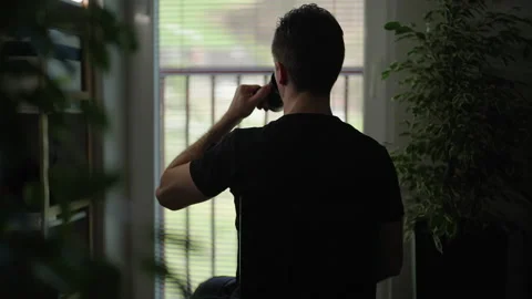 Man silhouette watching through window d... | Stock Video | Pond5