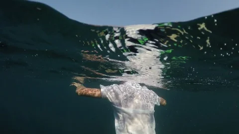 man sinking into the sea | Stock Video | Pond5