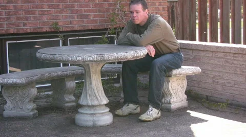Man sitting and comtemplating at outdoor... | Stock Video | Pond5