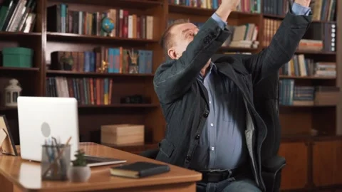 The man is sitting in a chair and sudden... | Stock Video | Pond5