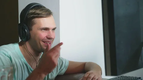 Man sitting at desk looking at computer ... | Stock Video | Pond5