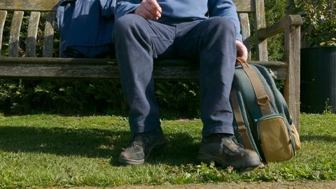 Man sitting down with backpack on a wood... | Stock Video | Pond5