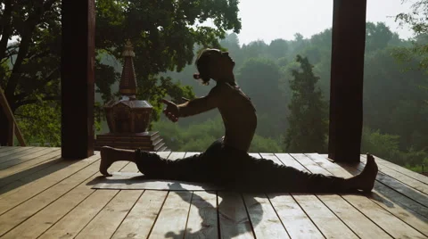 Man sitting on splits and yoga | Stock Video | Pond5