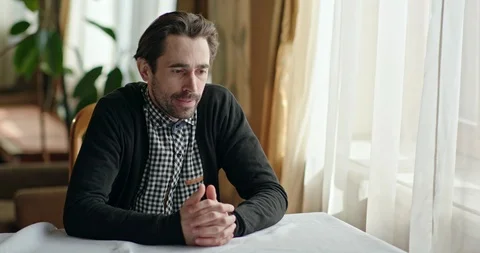 Man sitting thinking muttering to himsel... | Stock Video | Pond5