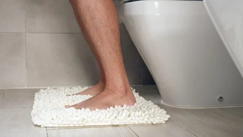 Man sitting on wc toilet bowl at the bat... | Stock Video | Pond5