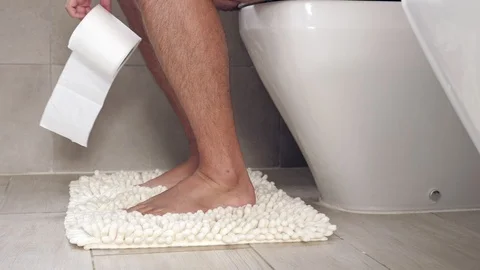 Man sitting on wc toilet bowl at the bat... | Stock Video | Pond5