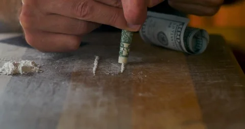 Man snorting a line of white powder up h... | Stock Video | Pond5