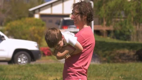 A man spinning around a cute young boy o... | Stock Video | Pond5