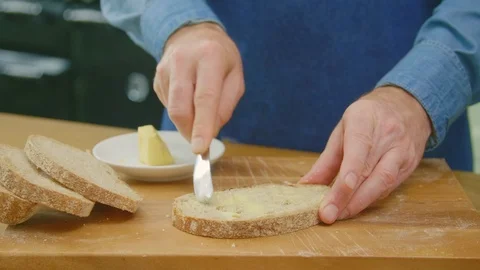 Man Spreading Butter On Bread With Knife... | Stock Video | Pond5