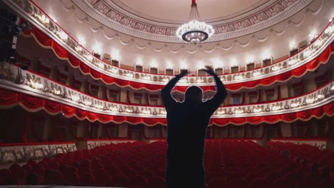 Man on stage in empty theater. Back view... | Stock Video | Pond5