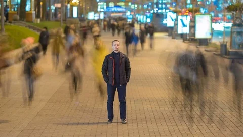 The man stand in the ghost-like crowd fl... | Stock Video | Pond5