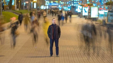 The man stand in the ghost-like crowd fl... | Stock Video | Pond5