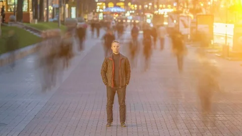 Man stand in ghost crowd stream. sunset ... | Stock Video | Pond5