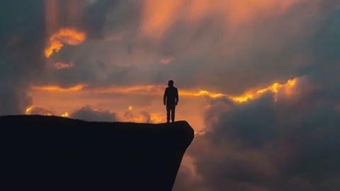 The man stand on the rock edge by thunde... | Stock Video | Pond5