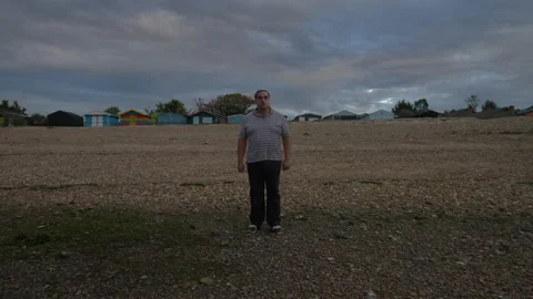 Man Standing Looking out Pebble Beach wi... | Stock Video | Pond5