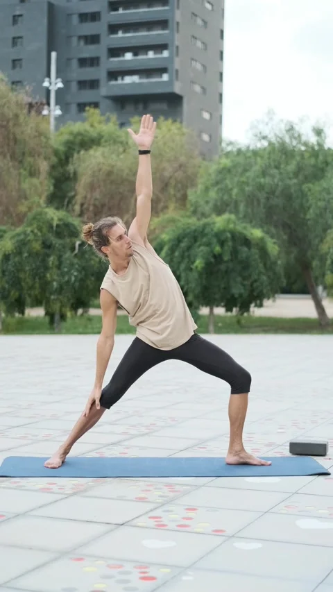 Man standing on a mat and bending sidewa... | Stock Video | Pond5