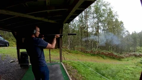 Man standing at shooting range and fire ... | Stock Video | Pond5