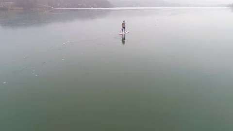 Man standing on stand up paddleboard on ... | Stock Video | Pond5