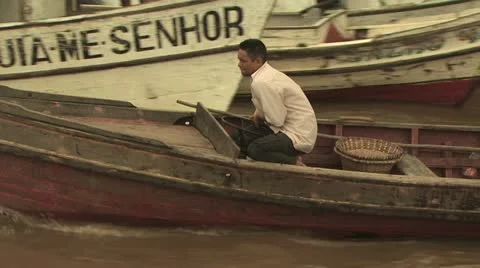 Man Steering a Small Boat Out Onto the A... | Stock Video | Pond5