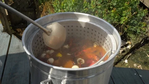 Man Stirs Crawfish Boil in Pot | Stock Video | Pond5