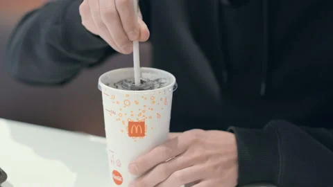 Man student drinks Coca cola at McDonald... | Stock Video | Pond5