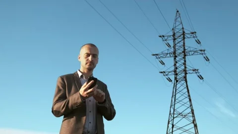 A man in a suit, high-voltage power line... | Stock Video | Pond5