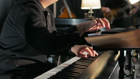 Man in suit playing two keyboards with b... | Stock Video | Pond5