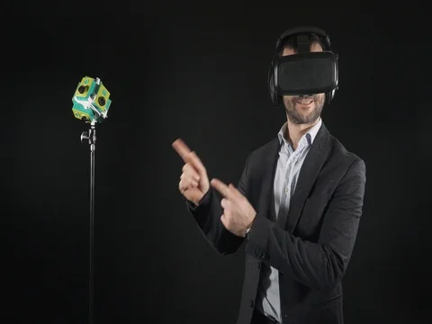 Man in suit uses virtual reality goggles... | Stock Video | Pond5