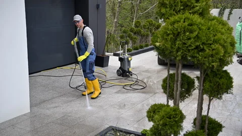 Man in Suit Using Pressure Washer on a D... | Stock Video | Pond5