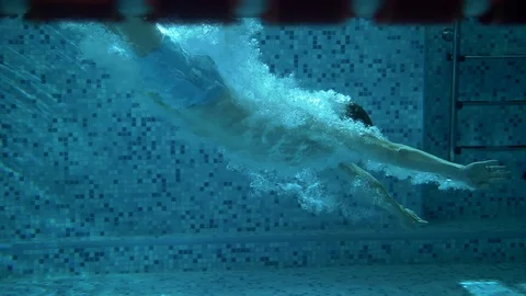 Man in swimming shorts slowly sinking in... | Stock Video | Pond5