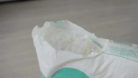 A man takes one diaper from the package ... | Stock Video | Pond5