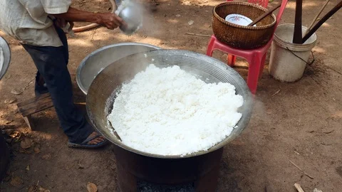 man taking fried rice out of a big wok ... | Stock Video | Pond5