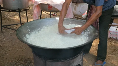 man taking fried rice out of a big wok a... | Stock Video | Pond5