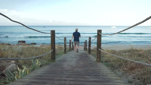Man taking a path made of wooden boards ... | Stock Video | Pond5