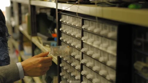 Man taking a transistor in a storage cab... | Stock Video | Pond5